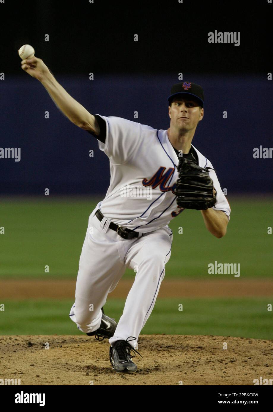 New York Mets pitcher John Maine winds up against the Colorado Rockies ...