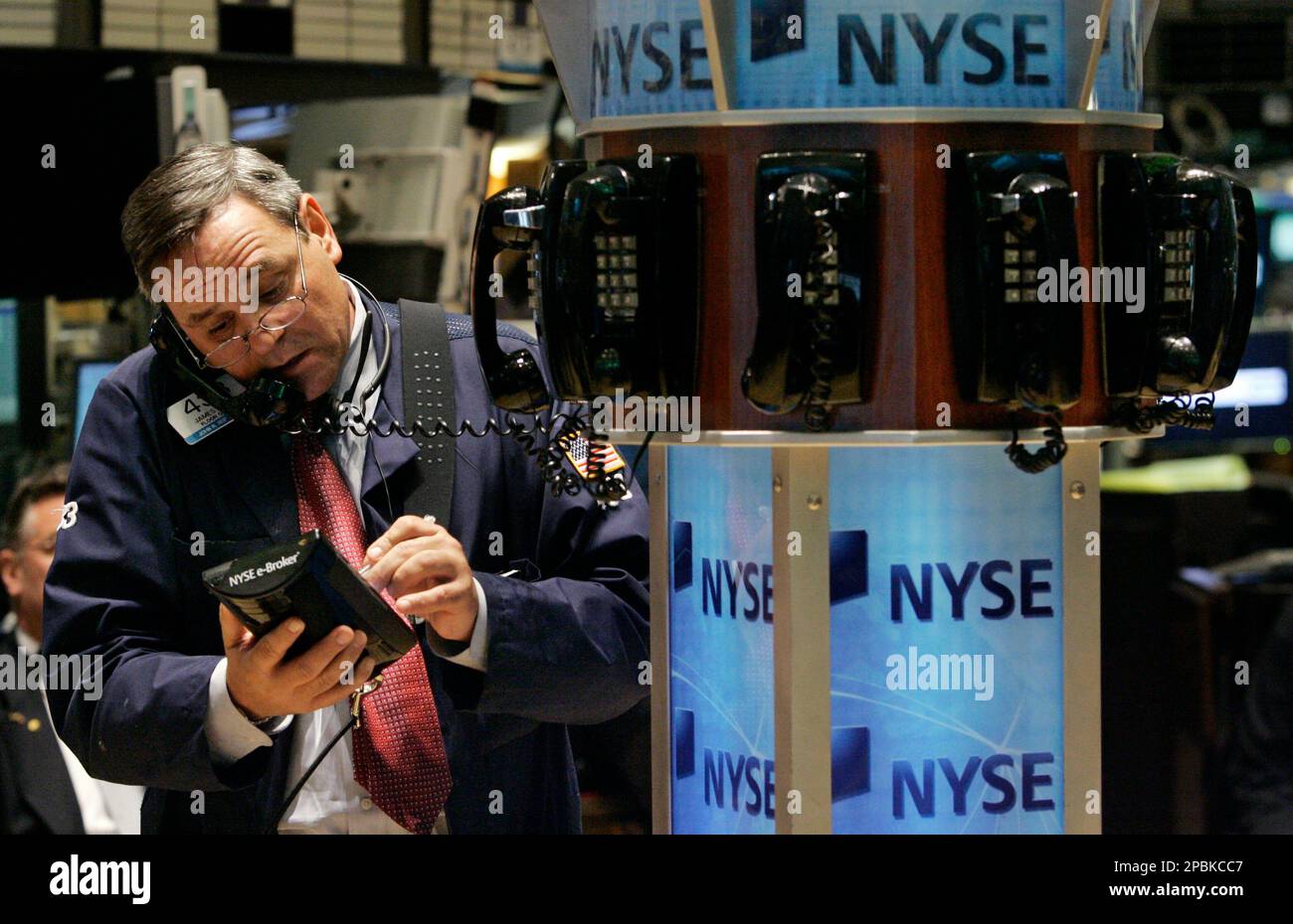 Trader James Seip uses a phone post on the floor of the New York Stock ...
