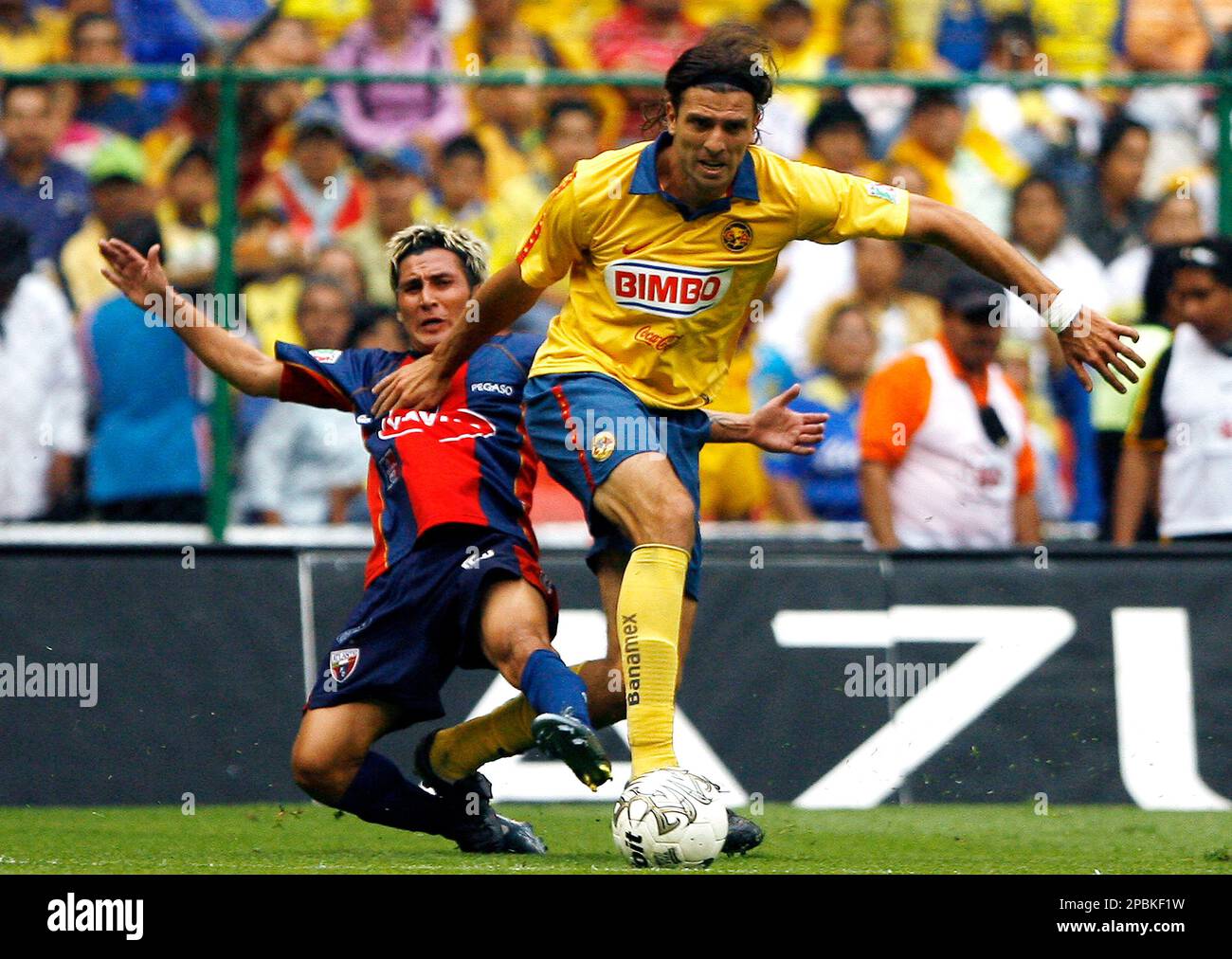 America's Daniel Bilos, from Argentina, right, fights for the ball with ...