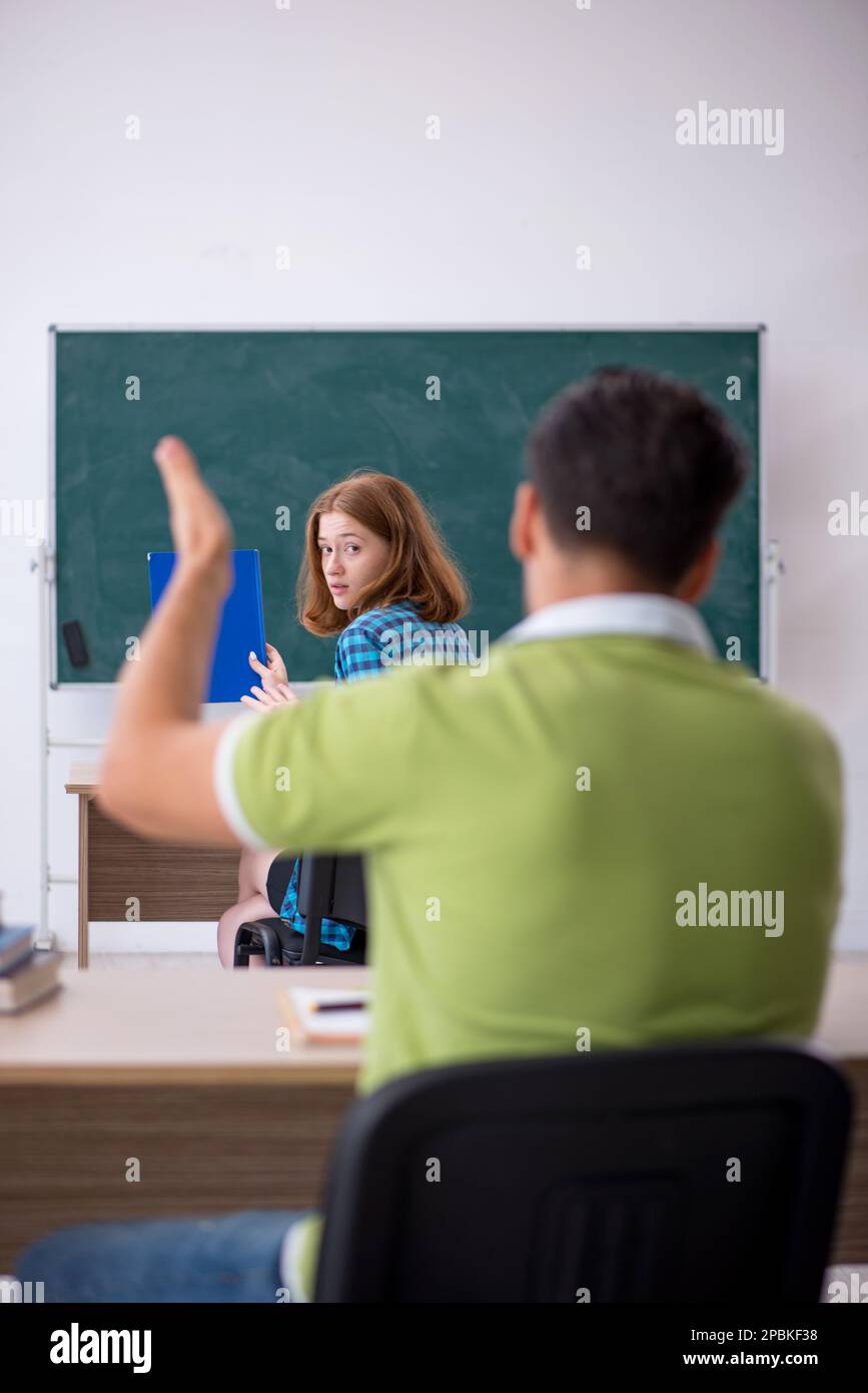Two students sitting in the class Stock Photo - Alamy