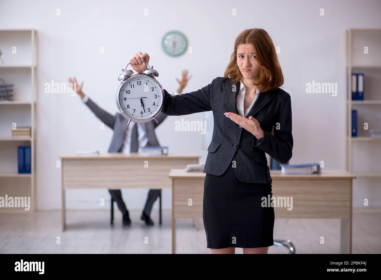 Two colleagues working in the workplace in time management concept ...