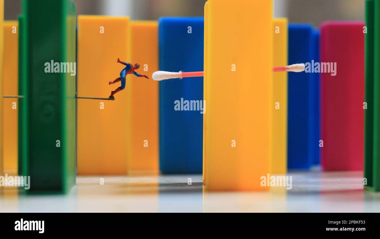 a miniature human figure with the power of a spider jumping over a ...