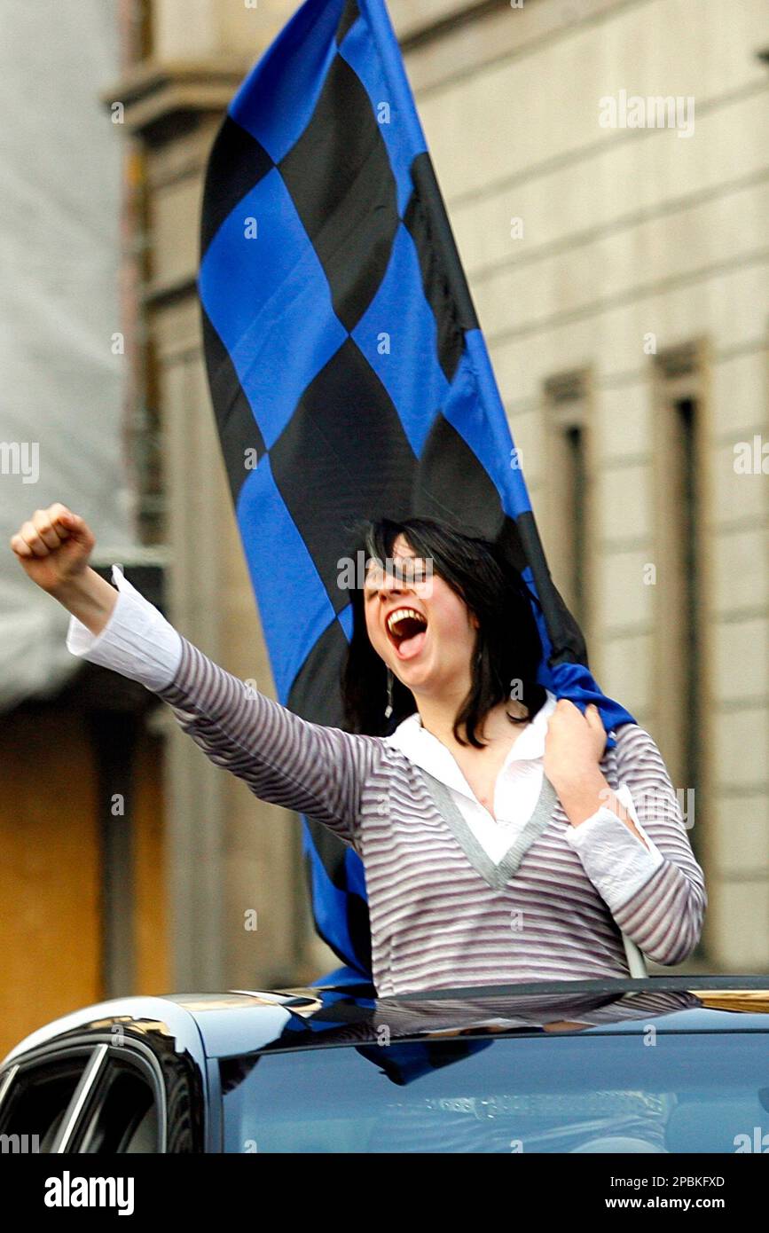 An Inter Milan supporter cheers for the "Scudetto" (tri-color shield ...