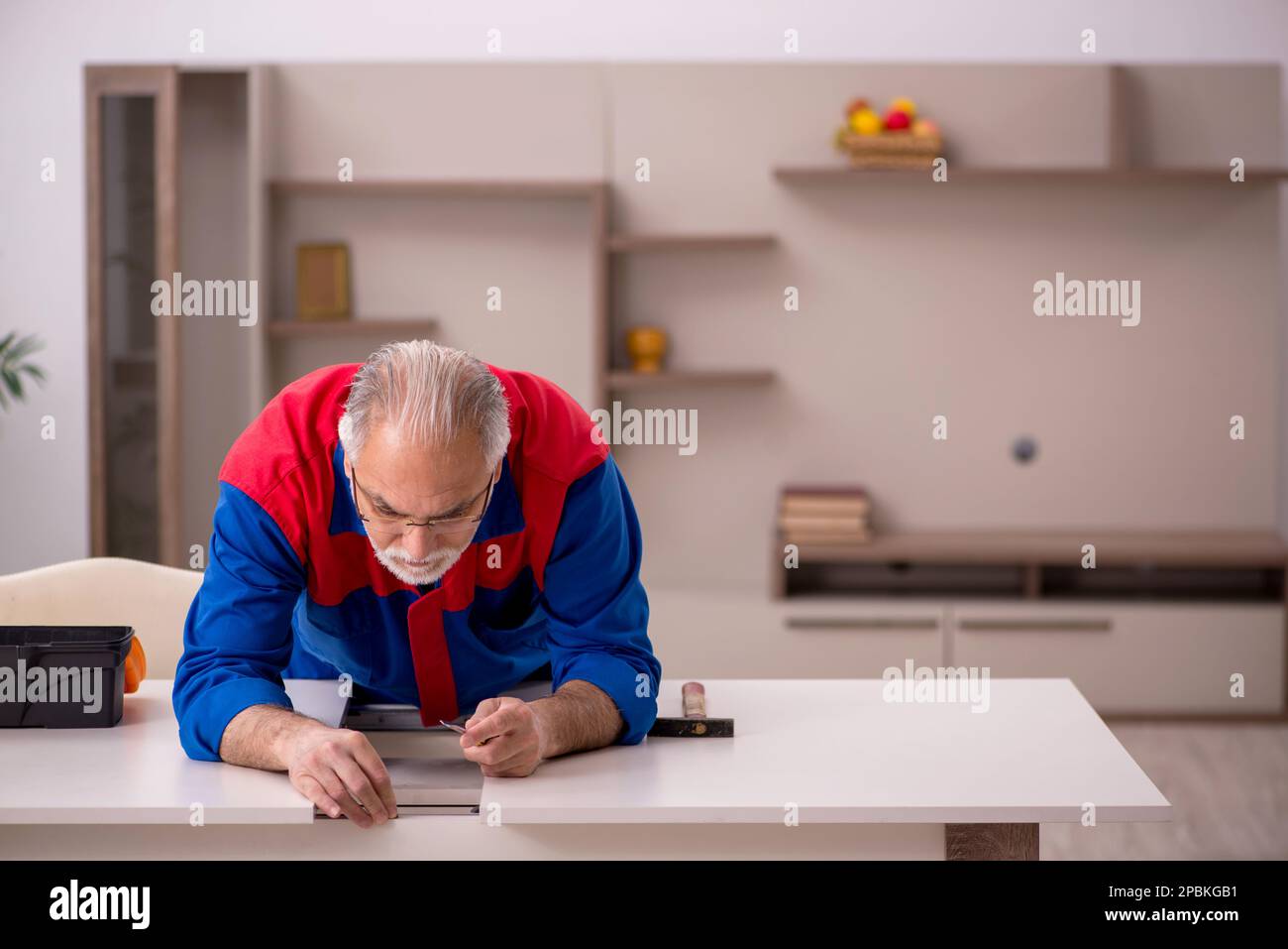 Old carpenter working at home Stock Photo - Alamy