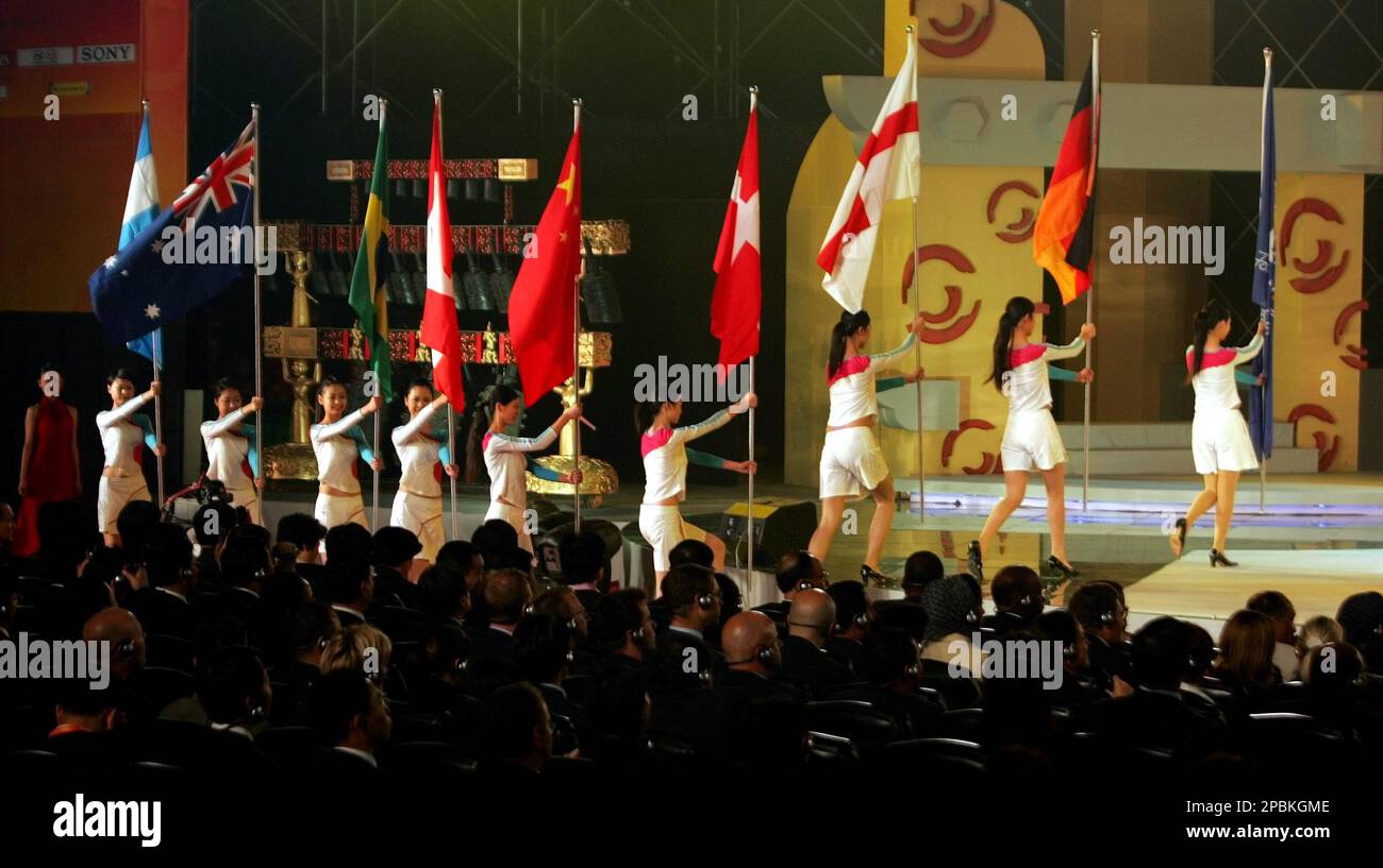 Chinese women parade with the flags of the countries competing in the ...