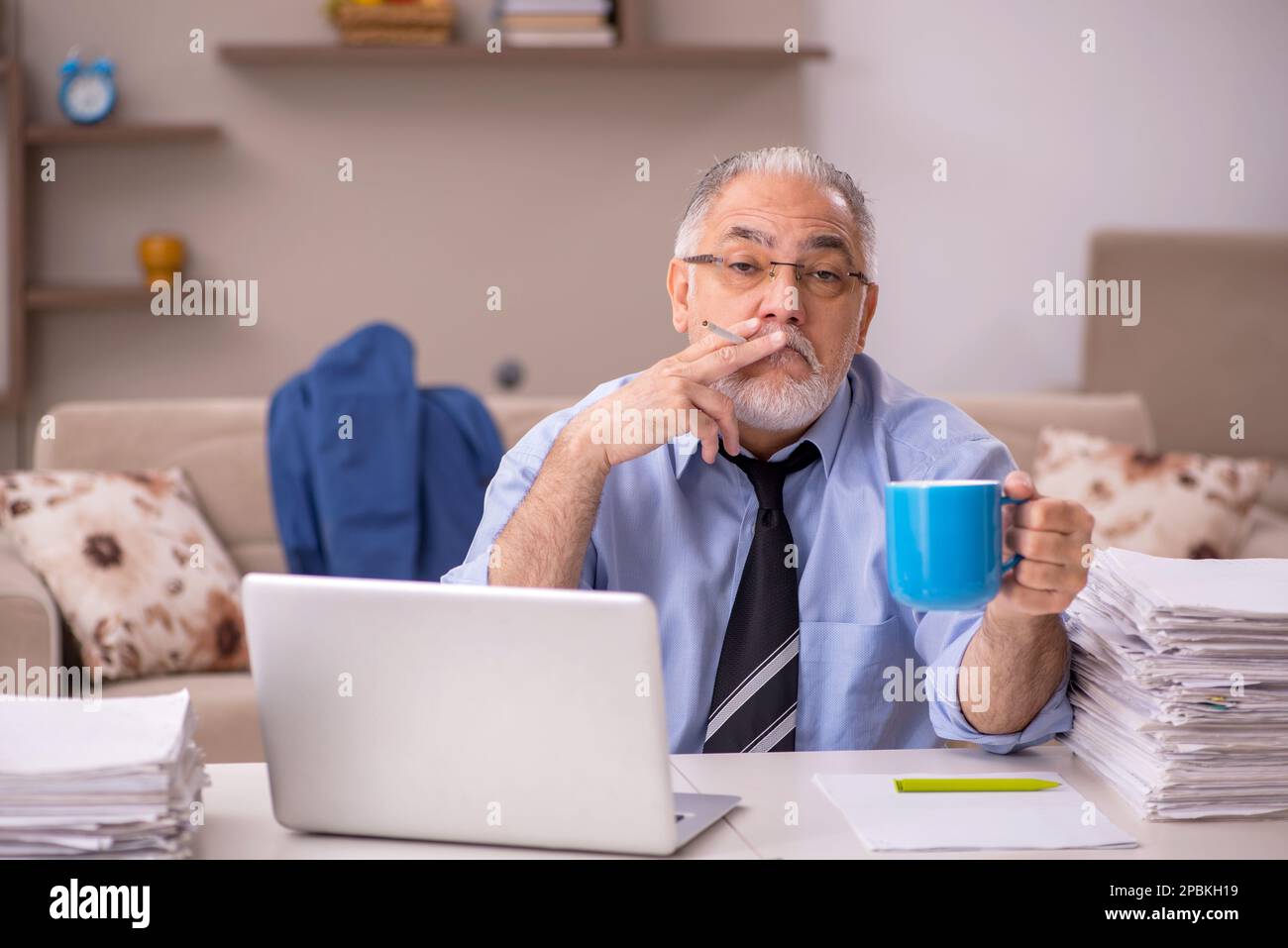 Old boss working from home during pandemic Stock Photo - Alamy