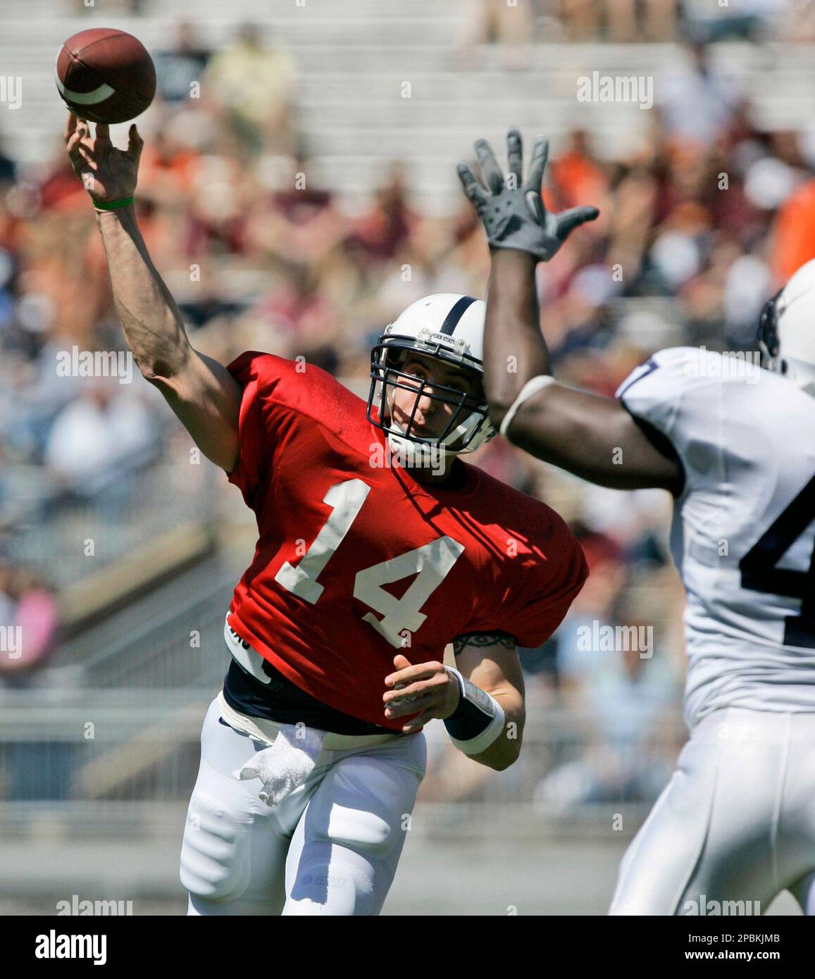 Penn State quarterback Anthony Morelli passes while rushed by the ...