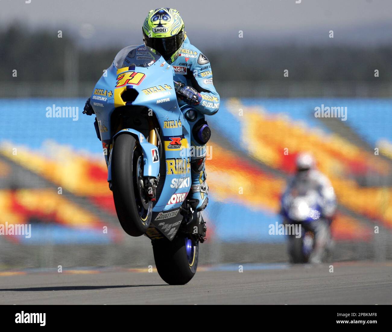 Rizla Suzuki Moto GP rider Chris Vermeulen of Australia lifts the front ...