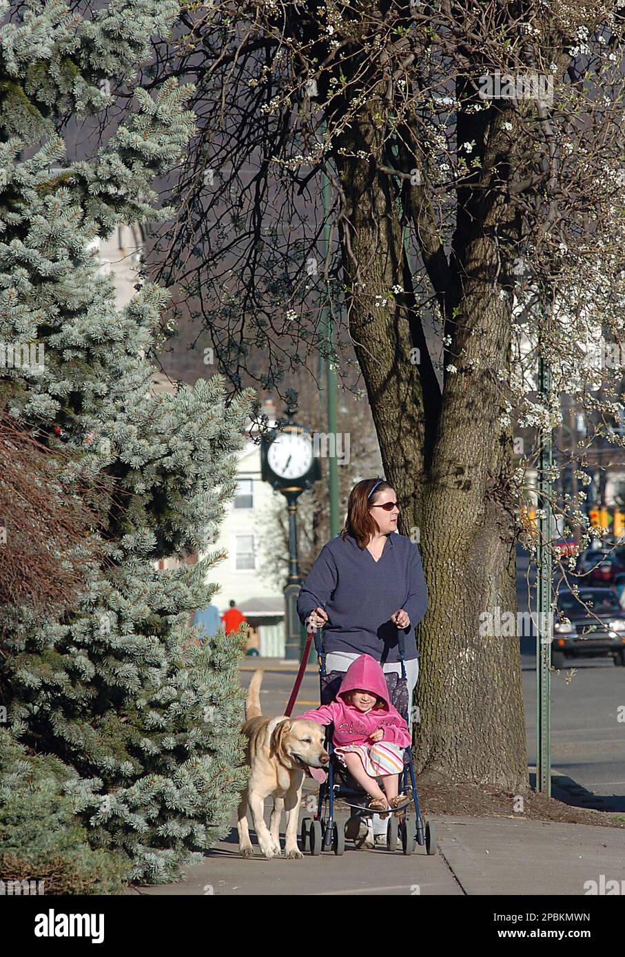 Kelly Raup pushes her daughter Emilia Raup, 5, while holding on the ...