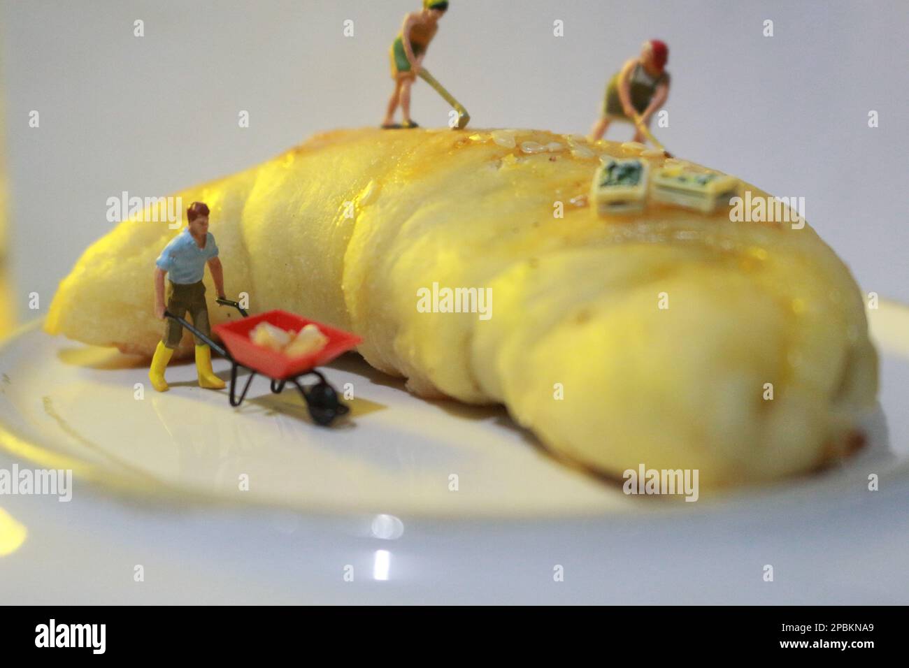 miniature figures of workers working together to move grain Stock Photo ...