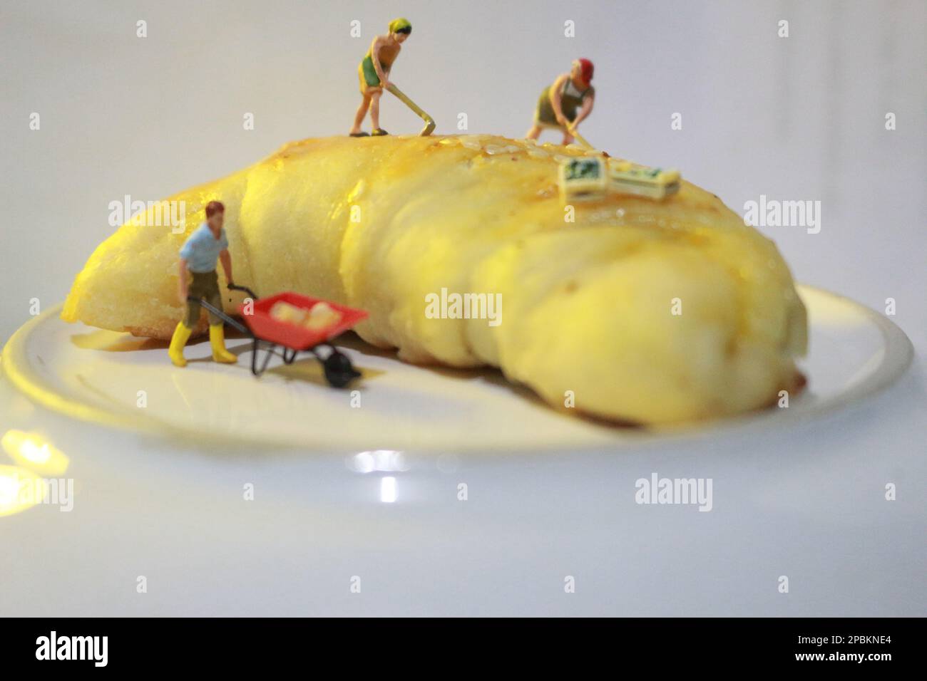miniature figures of workers working together to move grain Stock Photo ...