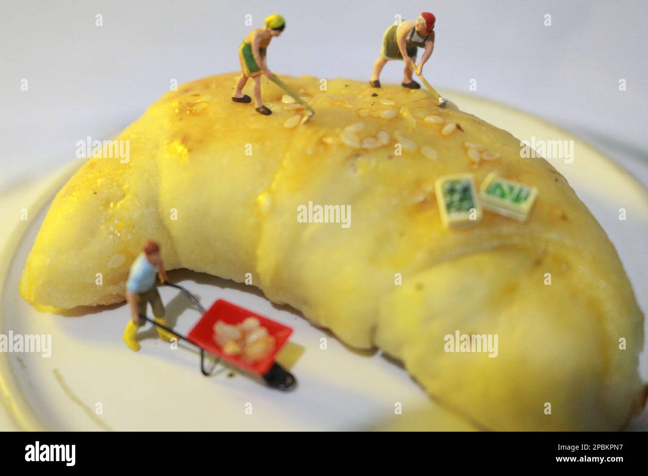 miniature figures of workers working together to move grain Stock Photo ...