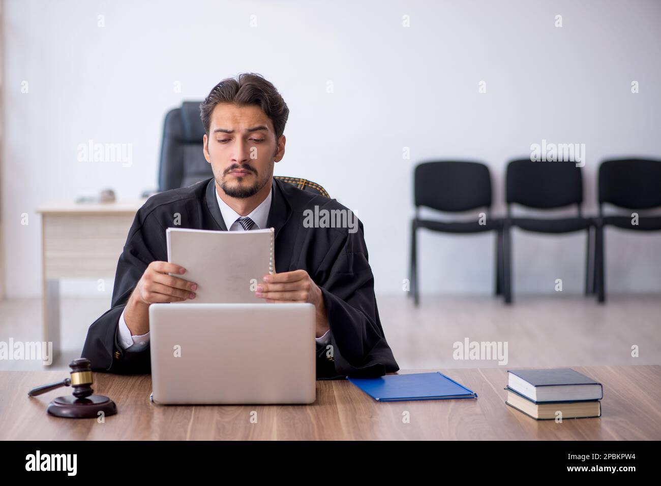 Young judge working in the courthouse Stock Photo - Alamy