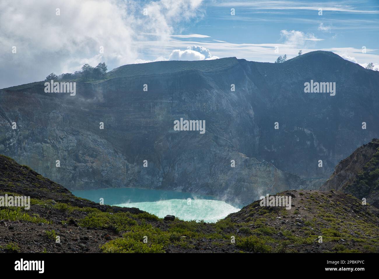 Panorama view of the sunlit turquoise crater lake of Mount Kelimutu ...