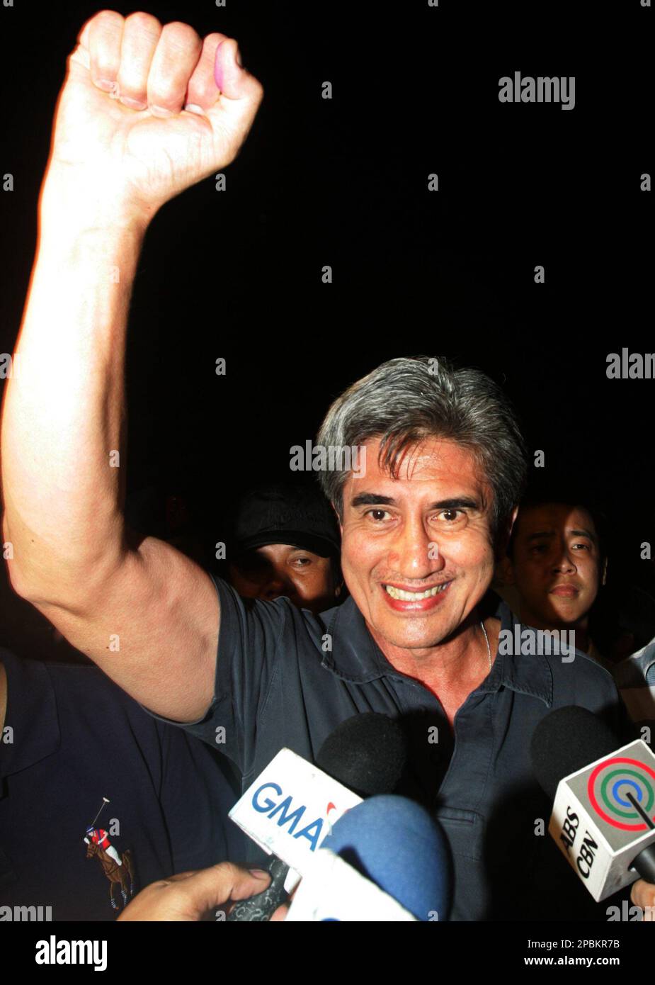 Detained former Senator Gregorio "Gringo" Honasan, clenches his fist ...