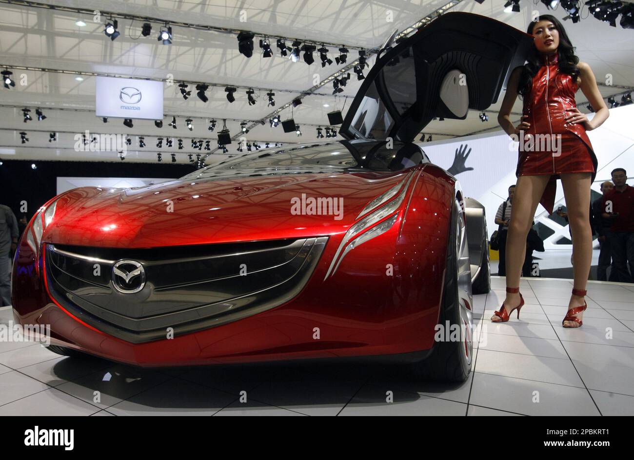 A Chinese model poses with the Ryuga, a concept car from Japanese ...