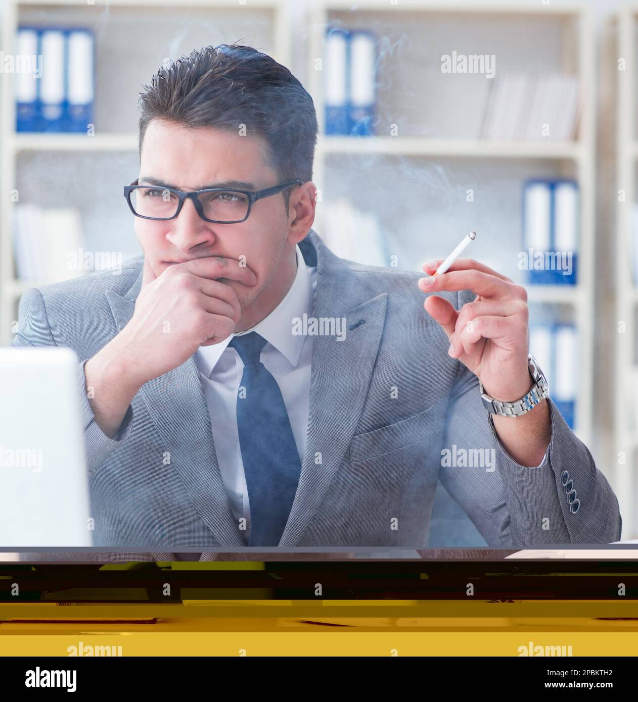 The businessman smoking in office at work Stock Photo - Alamy