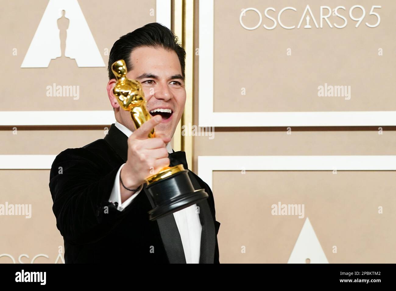 Jonathan Wang poses with the award for best picture for "Everything ...