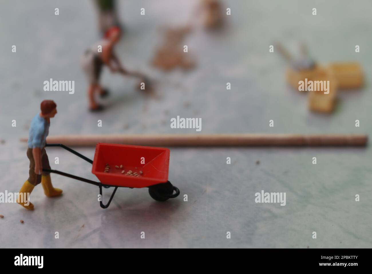 miniature figures of workers working together to move grain Stock Photo ...
