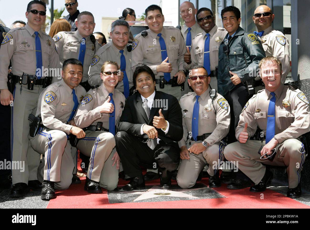 Erik Estrada, front center, poses with California Highway Patrol officers on the Hollywood Walk ...