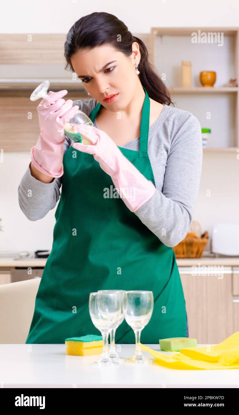 The young female contractor doing housework Stock Photo - Alamy