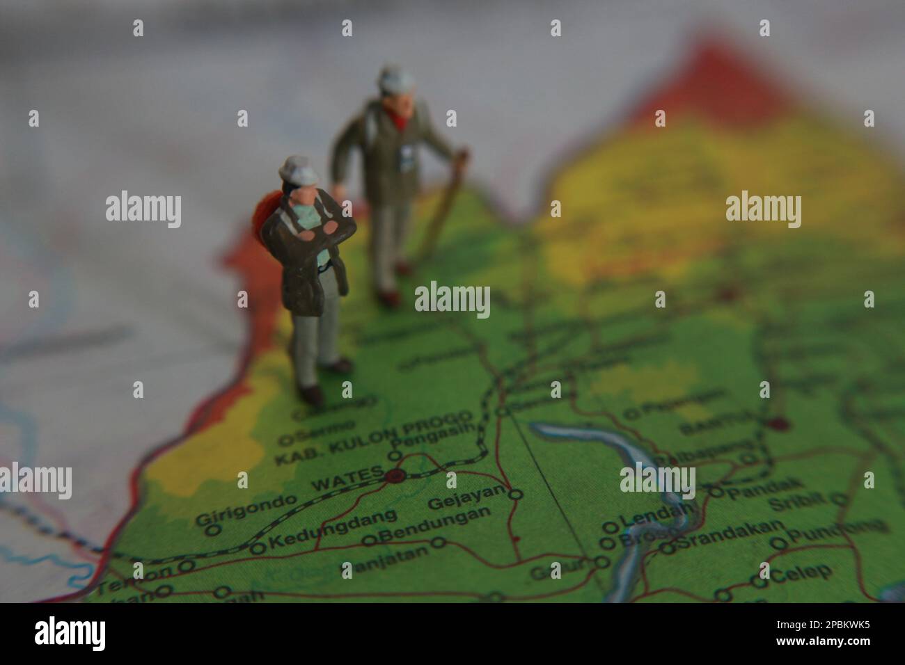 miniature figure of an explorer posing on a map or atlas Stock Photo ...