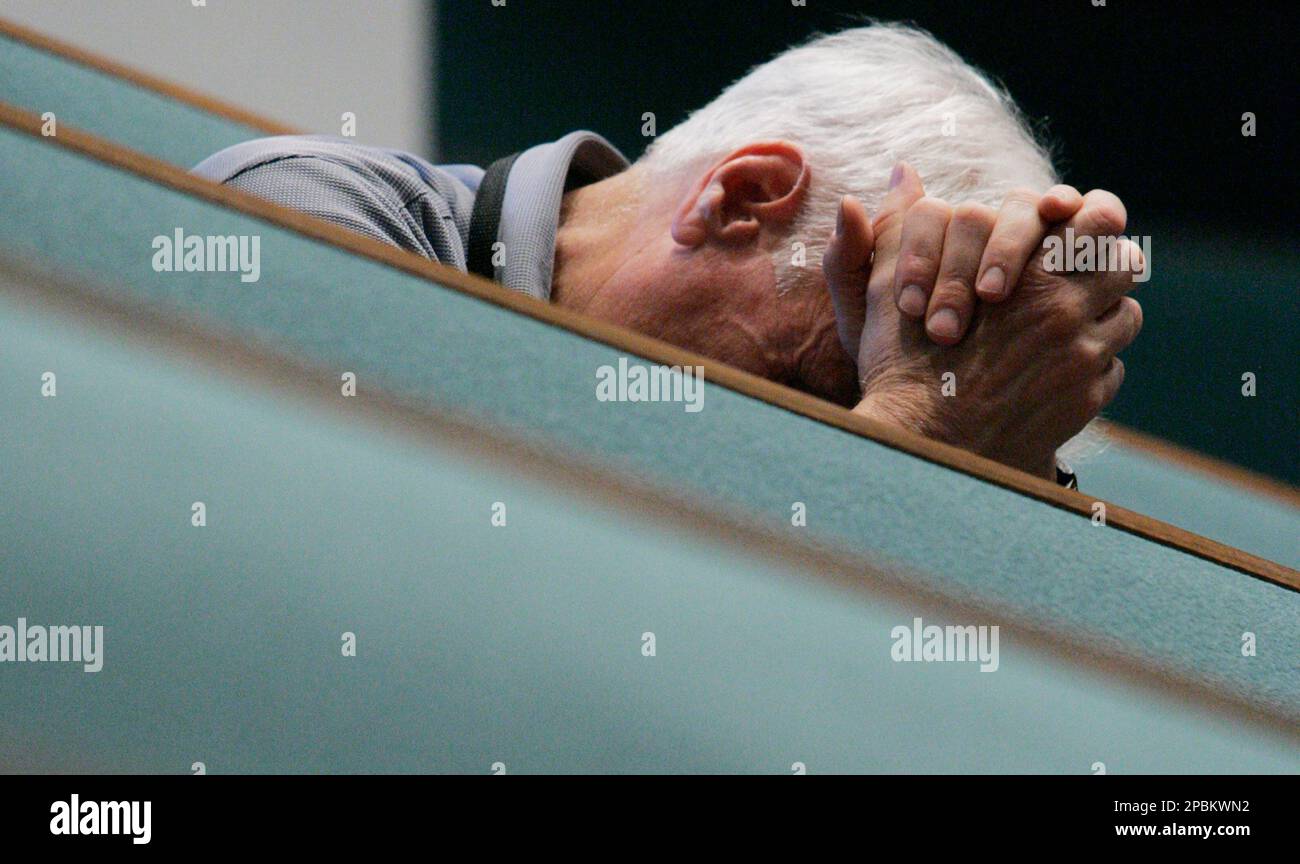 An unidentified mourner bows his head in prayer during a memorial ...