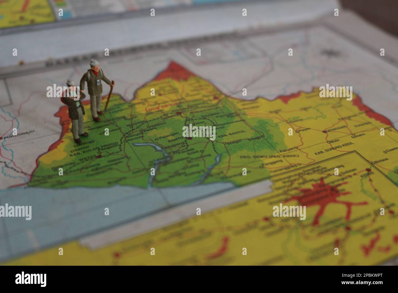 miniature figure of an explorer posing on a map or atlas Stock Photo ...