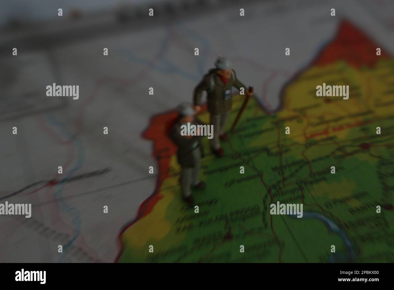 miniature figure of an explorer posing on a map or atlas Stock Photo ...