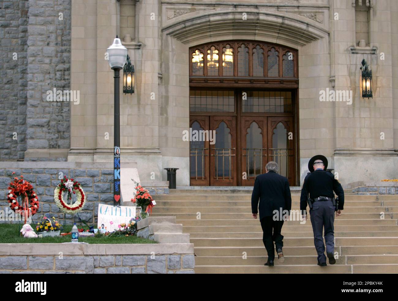 Virginia Tech President Charles Steger, left, and a state trooper walk ...