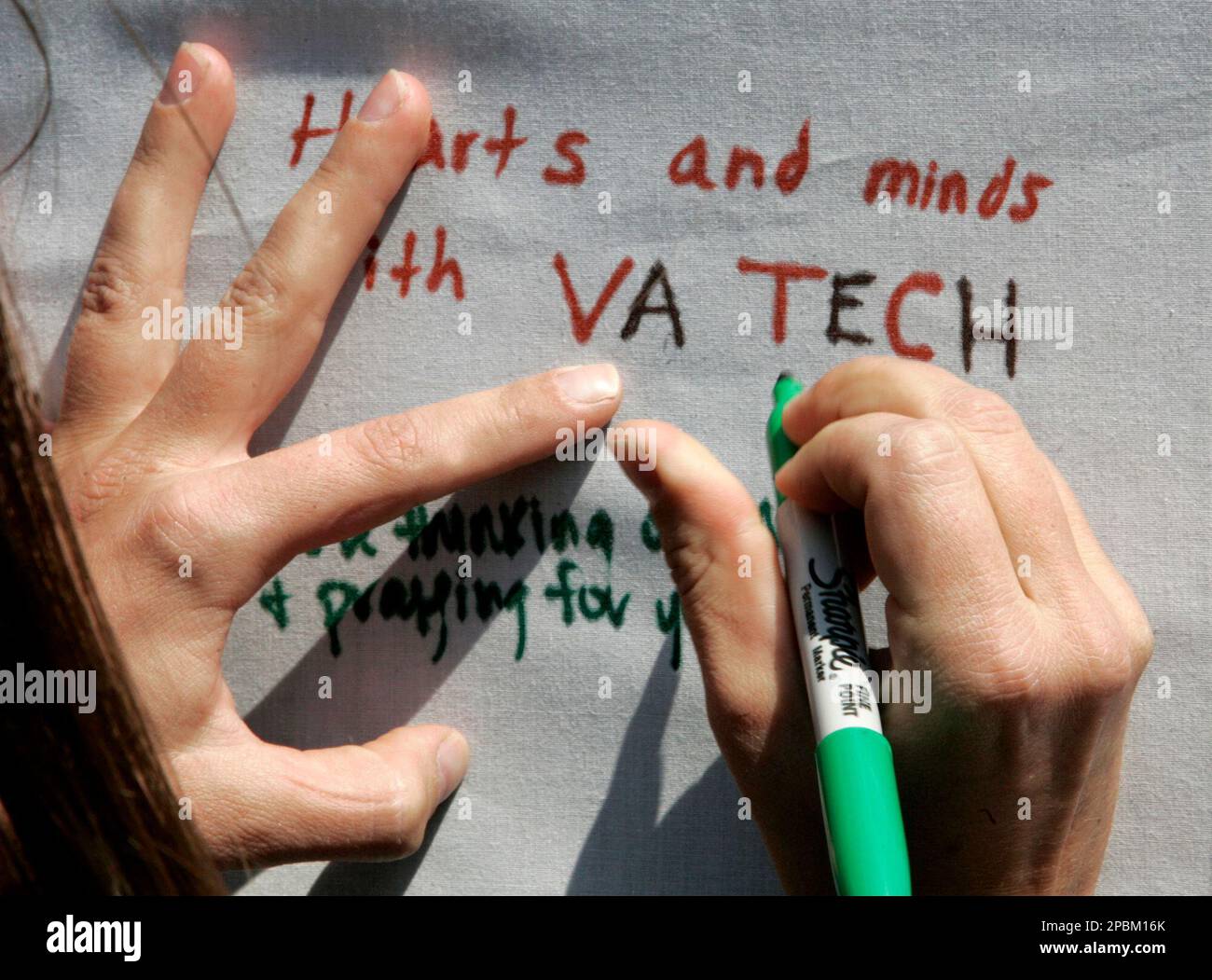 An Ohio State University student signs a message board Wednesday, April ...