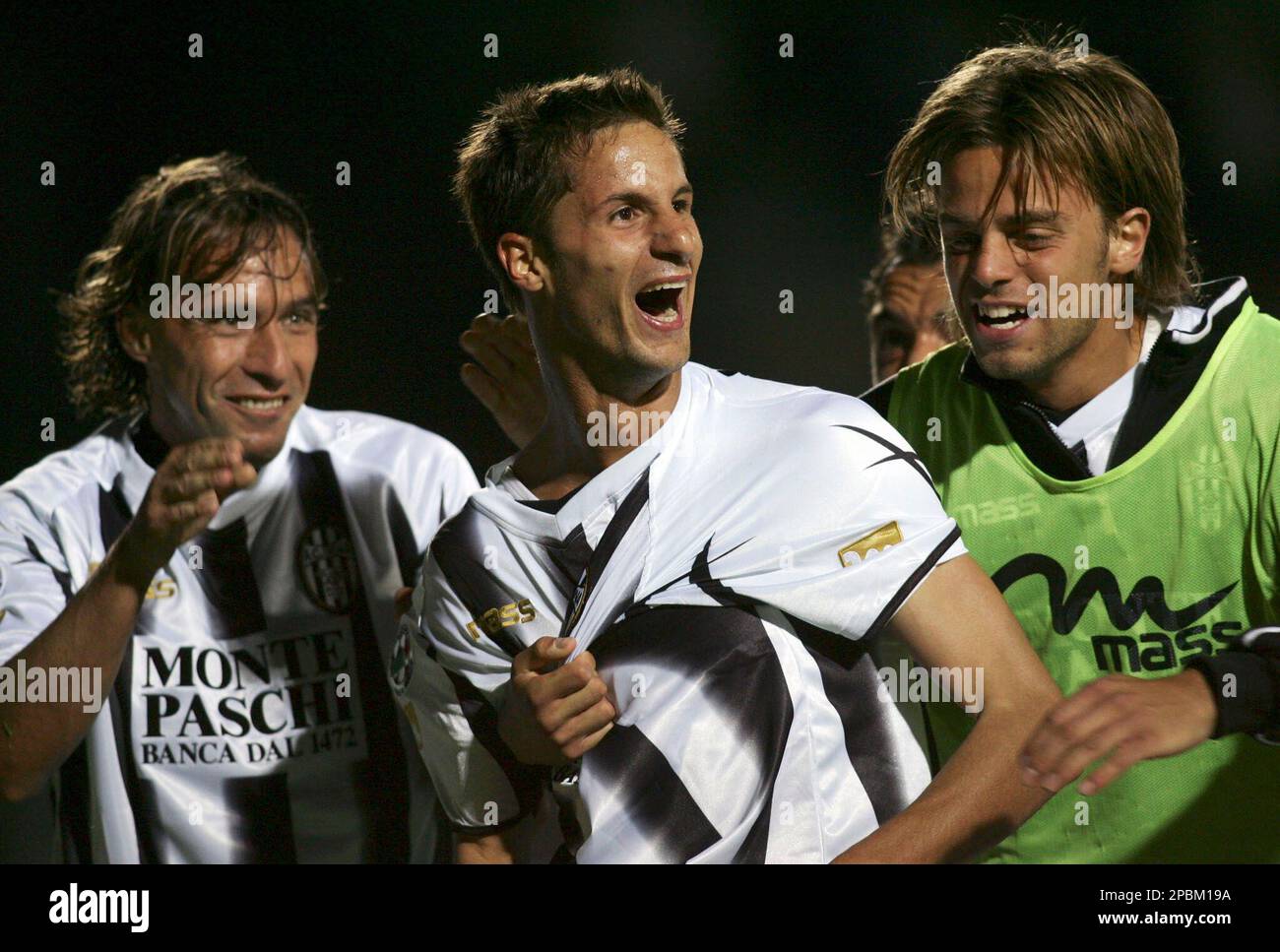 Siena's Luca Antonini, center, is celebrated by teammate Enrico Chiesa ...