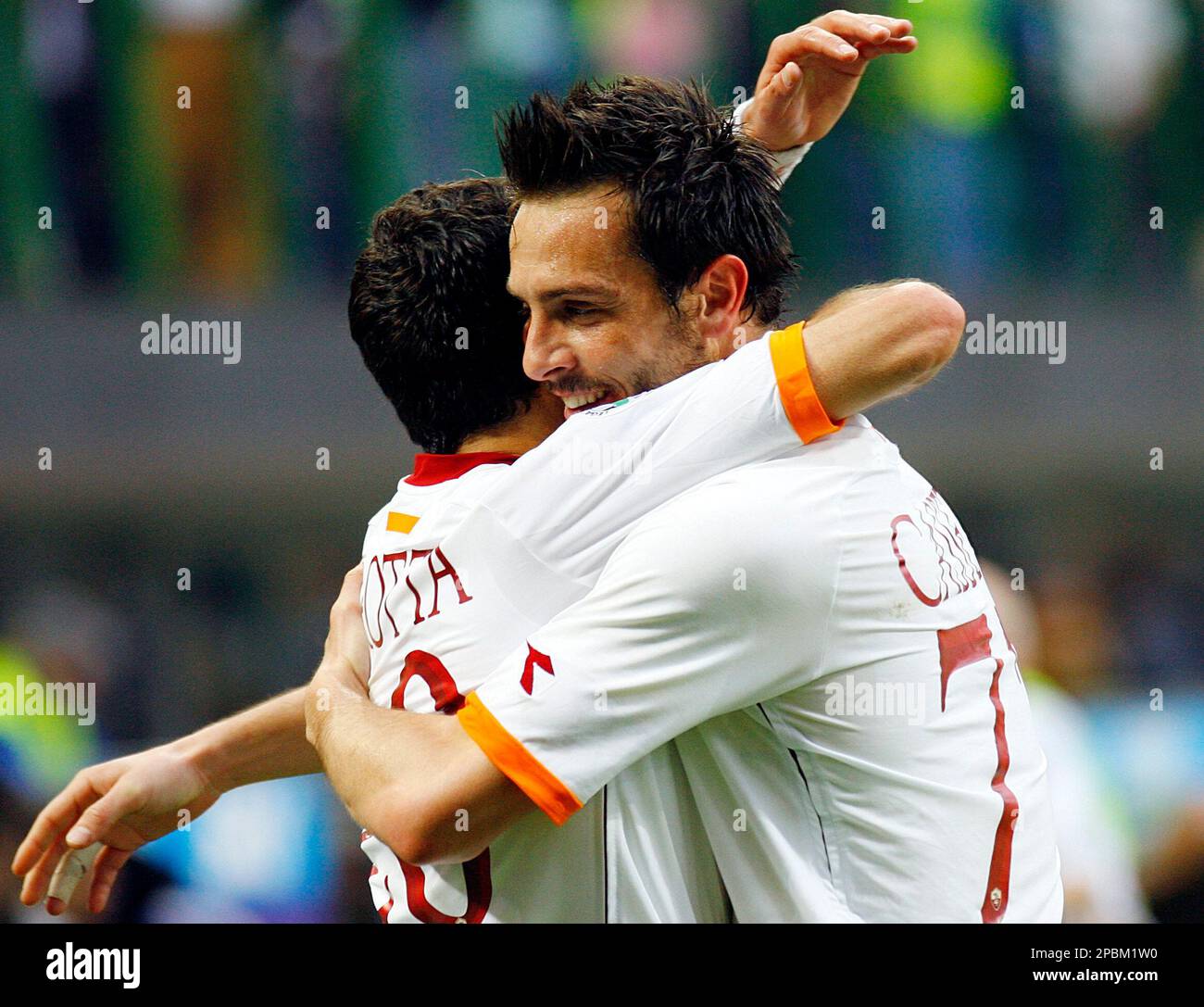 AS Roma defender Marco Cassetti, right, is hugged by his teammate ...