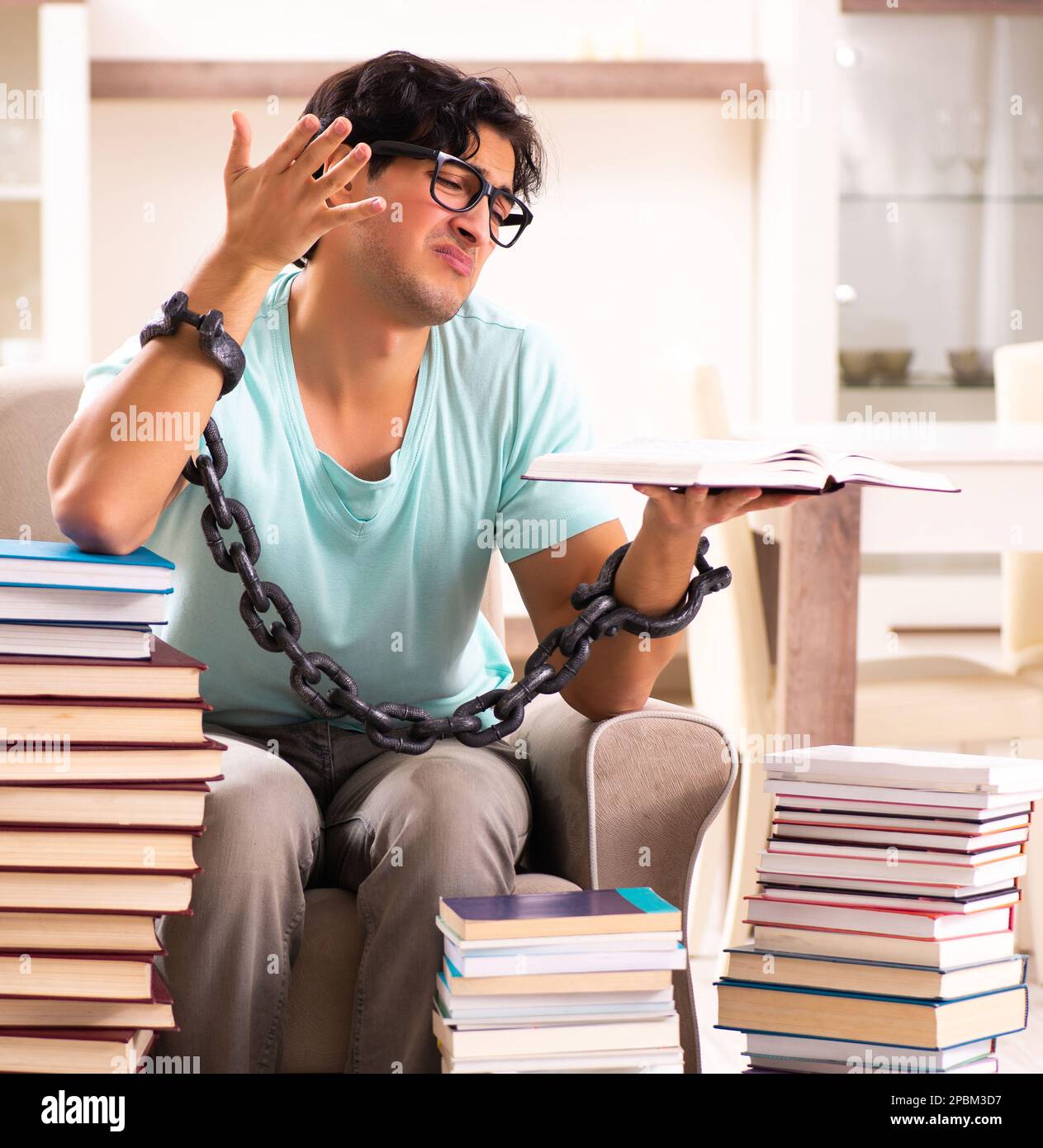 The male student with many books at home Stock Photo - Alamy