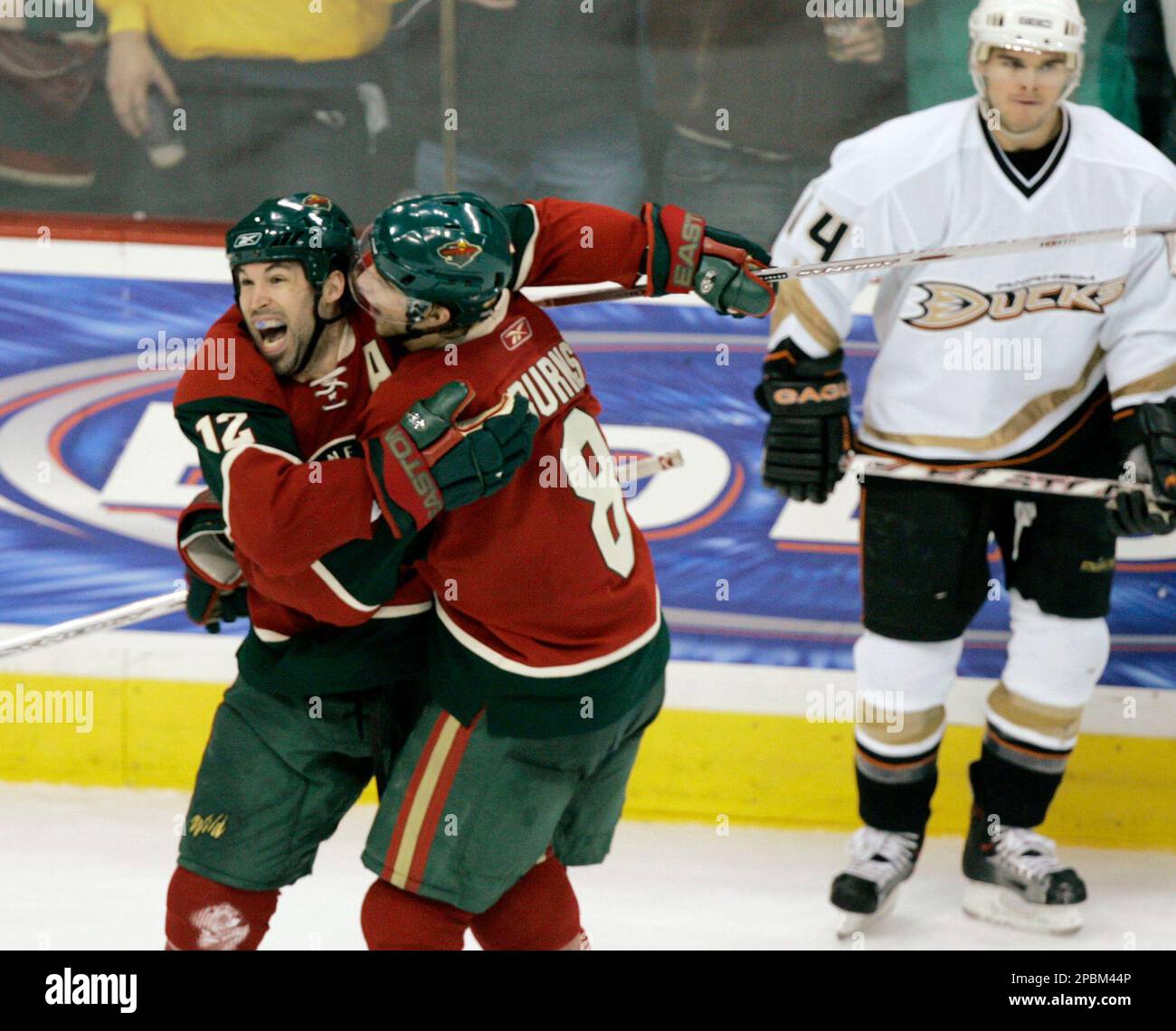 Anaheim Ducks' Chris Kunitz, right, stands by the boards as Minnesota Wild's Brent Burns, second ...