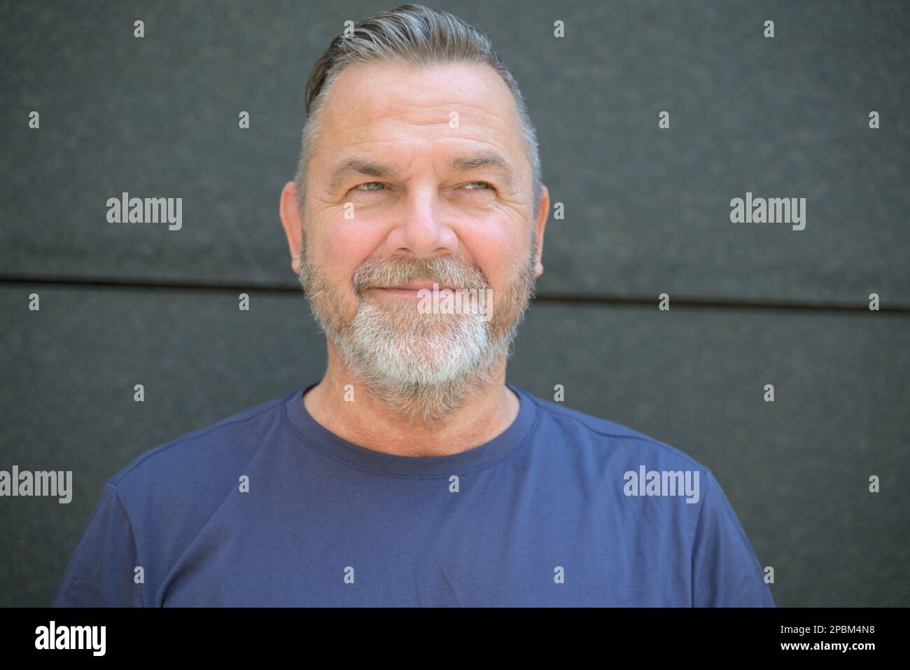 Happy vivacious bearded middle aged man head and shoulders portrait ...