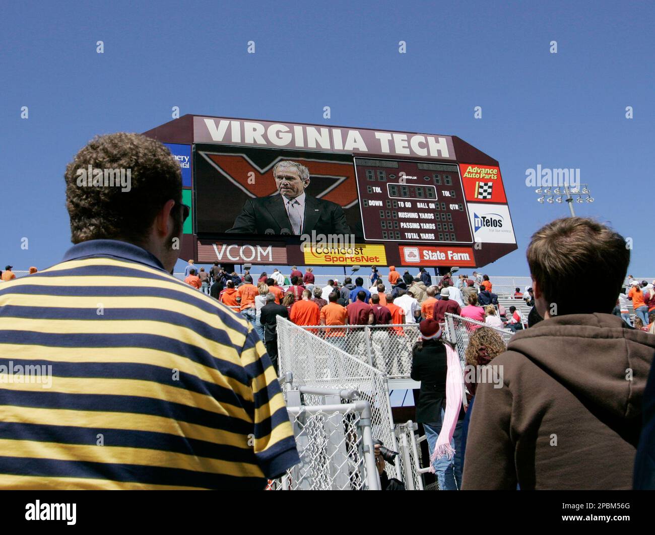 An overflow crowd of thousands watches as President Bush speaks on a ...