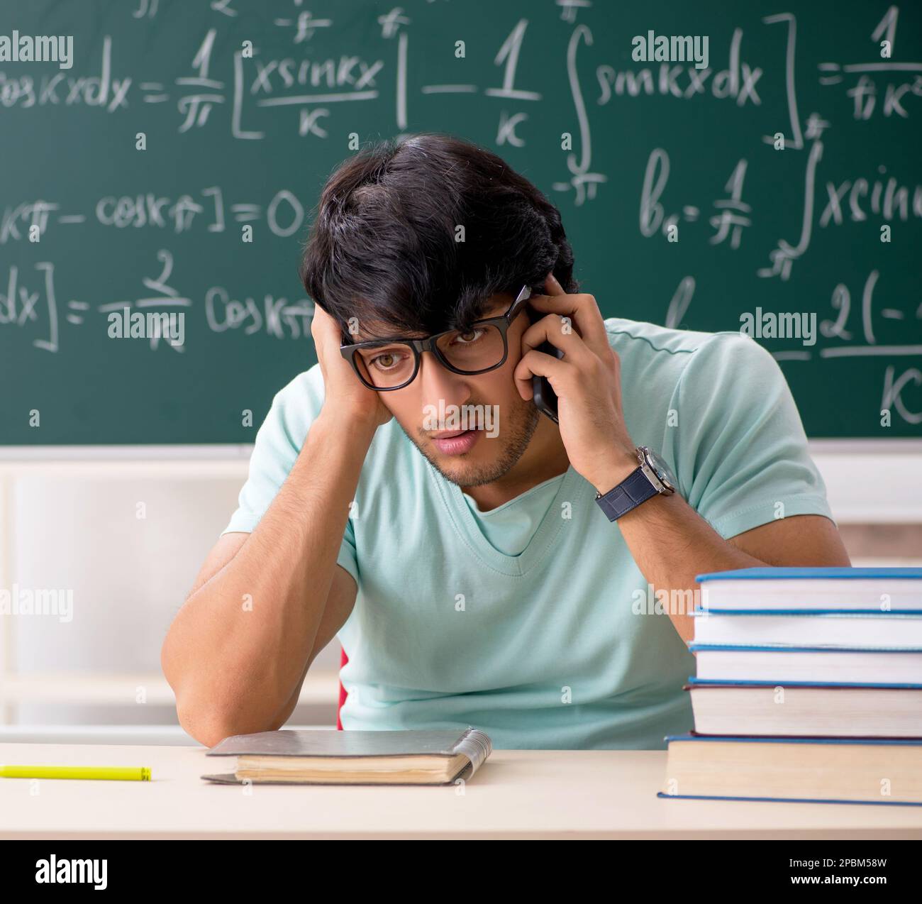 The young male student mathematician in front of chalkboard Stock Photo ...