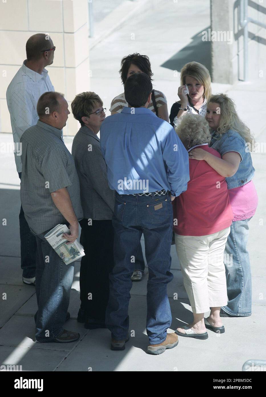 Members and friends of the Baird family meet outside the Tooele County ...