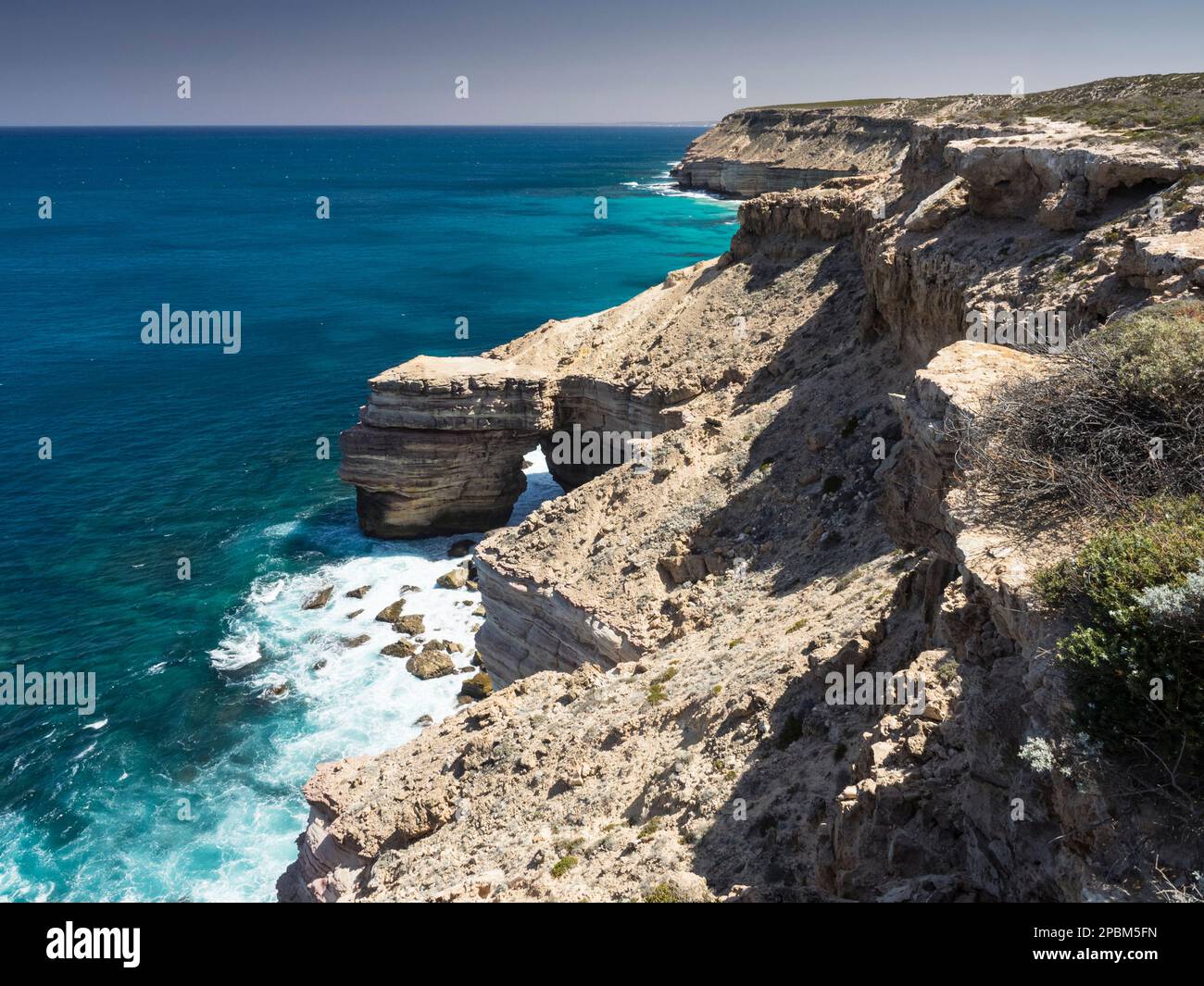 Natural Bridge and crumbling limestone clifftops above the relentless ...