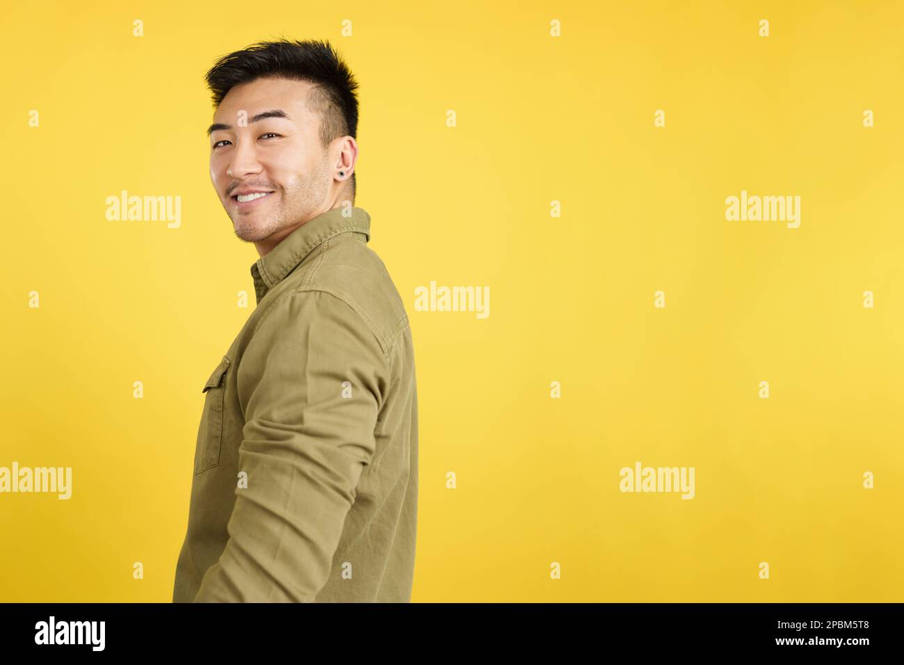 Happy chinese man turning to smile at the camera Stock Photo - Alamy