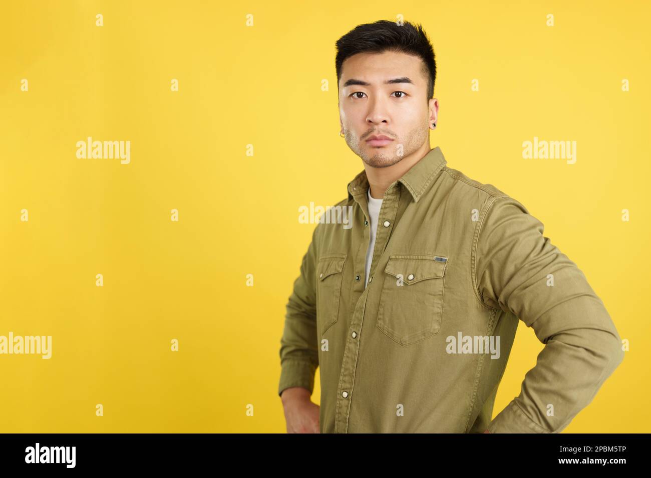 Confident chinese man standing looking at the camera Stock Photo - Alamy