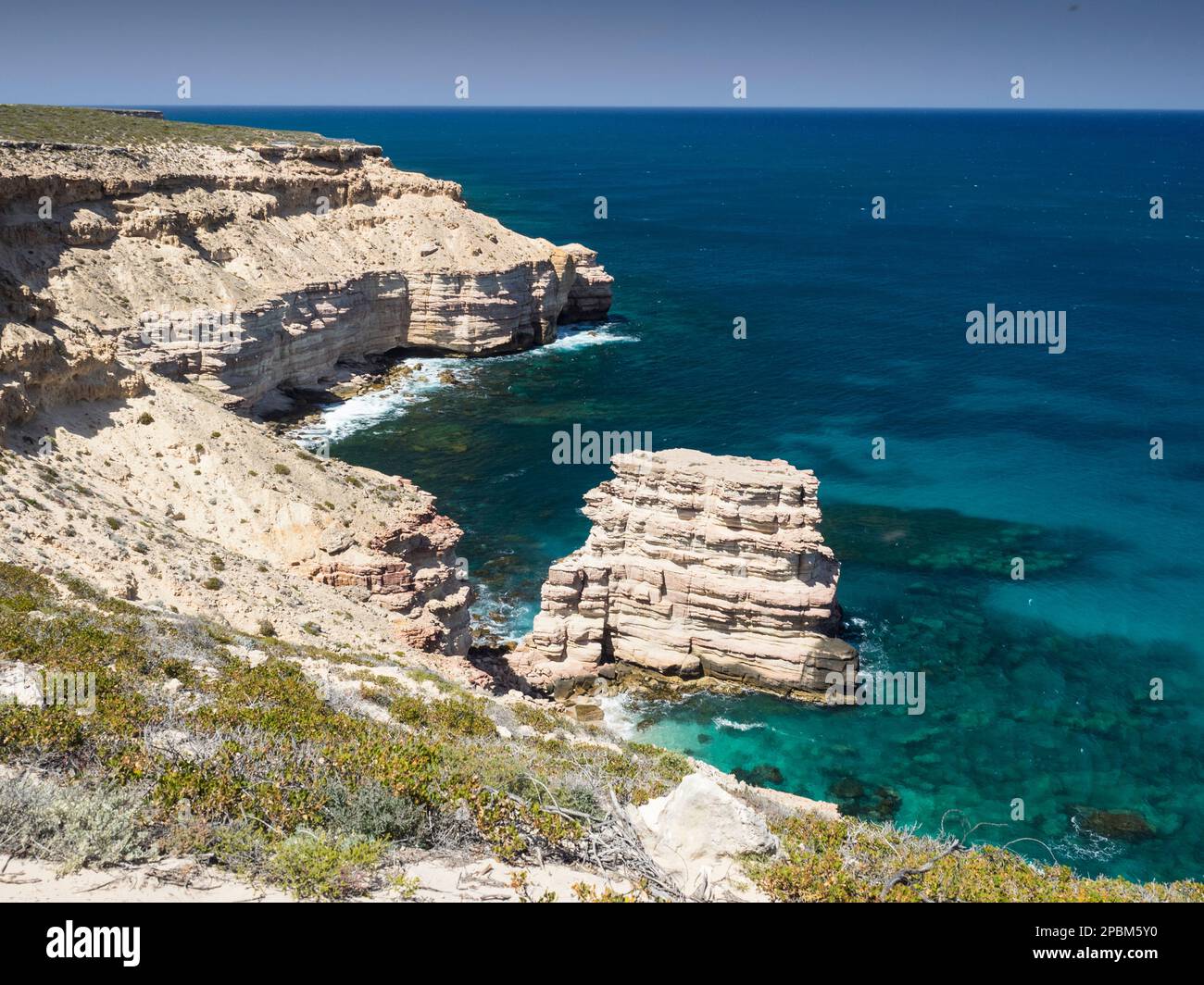 Island Rock and crumbling limestone clifftops above the relentless ...