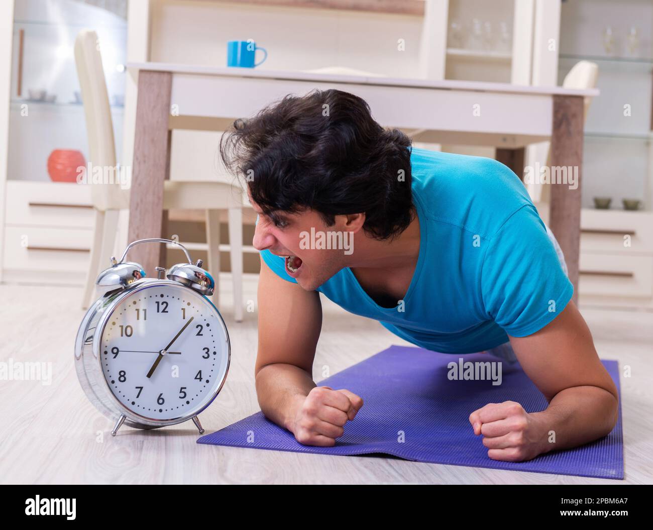 The young handsome man doing morning exercises Stock Photo - Alamy