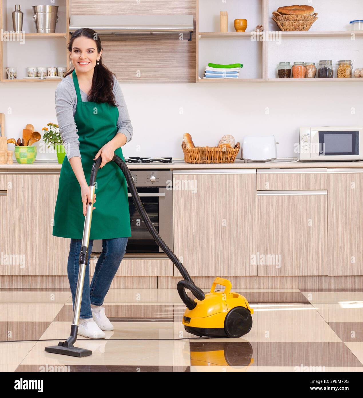 The young female contractor doing housework Stock Photo - Alamy