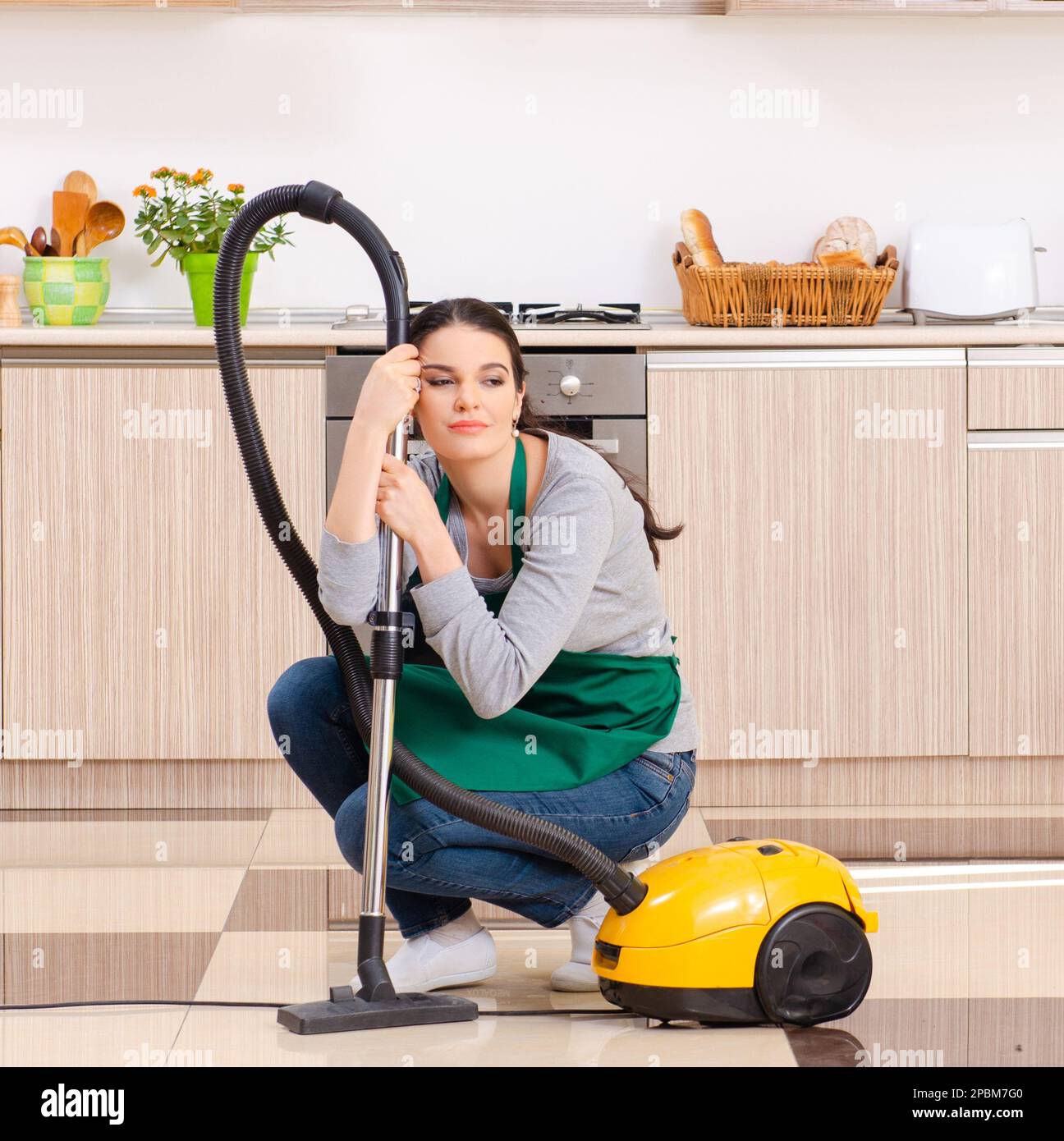 The young female contractor doing housework Stock Photo - Alamy