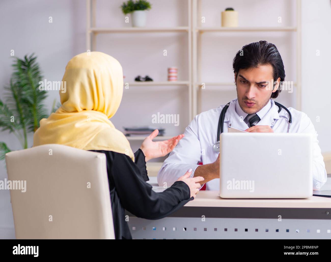 The female arab patient visiting male doctor Stock Photo - Alamy