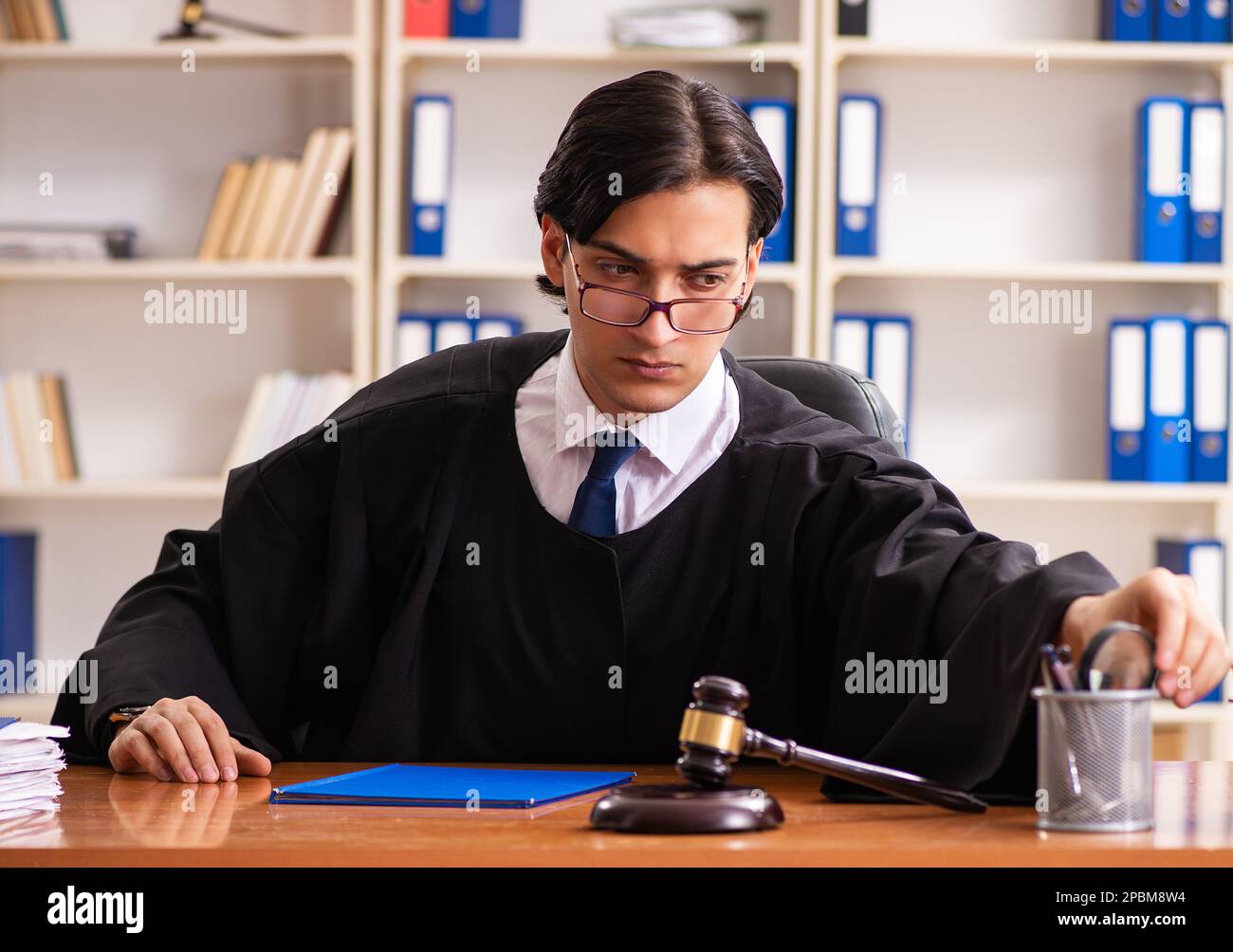 The young handsome judge working in court Stock Photo - Alamy