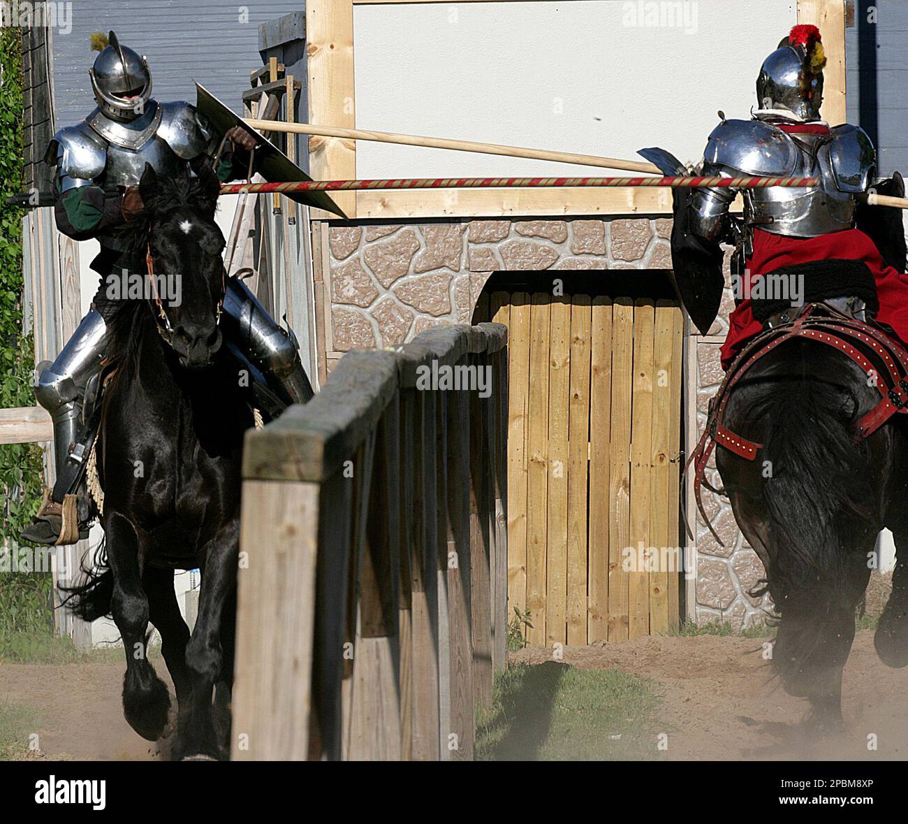 The Red & Gold Knight portrayed by Roland Martel, Right, strikes the ...