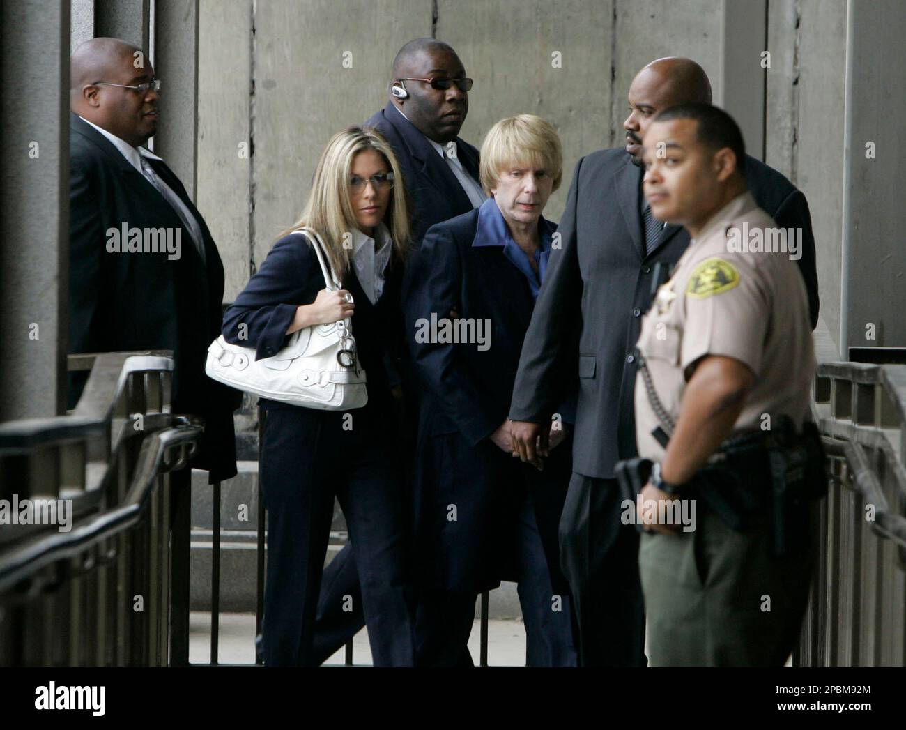 Surrounded by bodyguards, Phil Spector, center, arrives with his wife ...